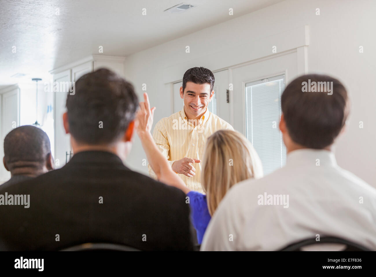 Businesswoman raising her hand in presentation Stock Photo - Alamy