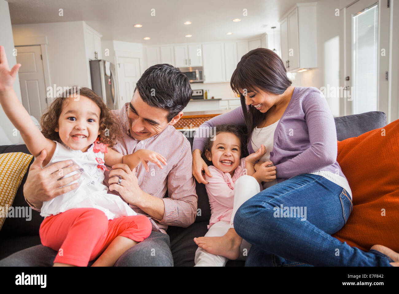 Family playing together on sofa Stock Photo - Alamy