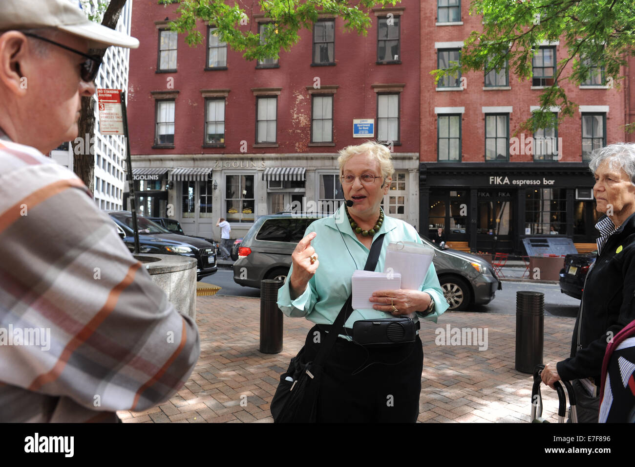 A tour guide on Pearl Street in Lower Manhattan, leading a tour about ...