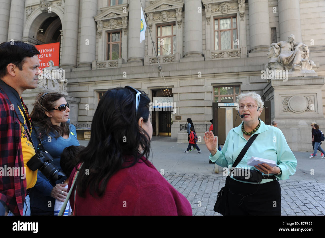 A tour guide in front of the landmarked National Museum of the American ...