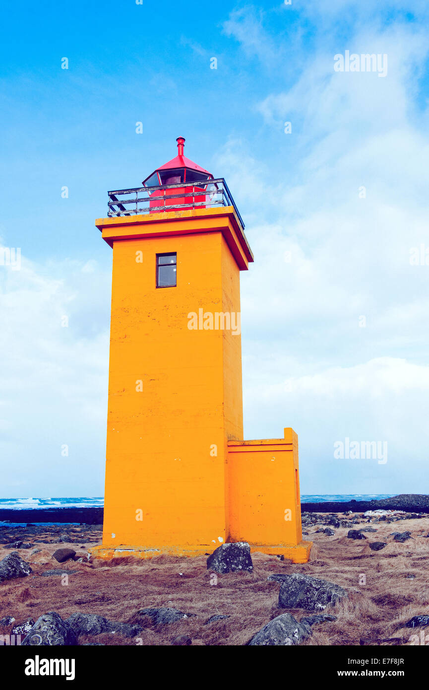 Lighthouse overlooking rocky landscape Stock Photo - Alamy