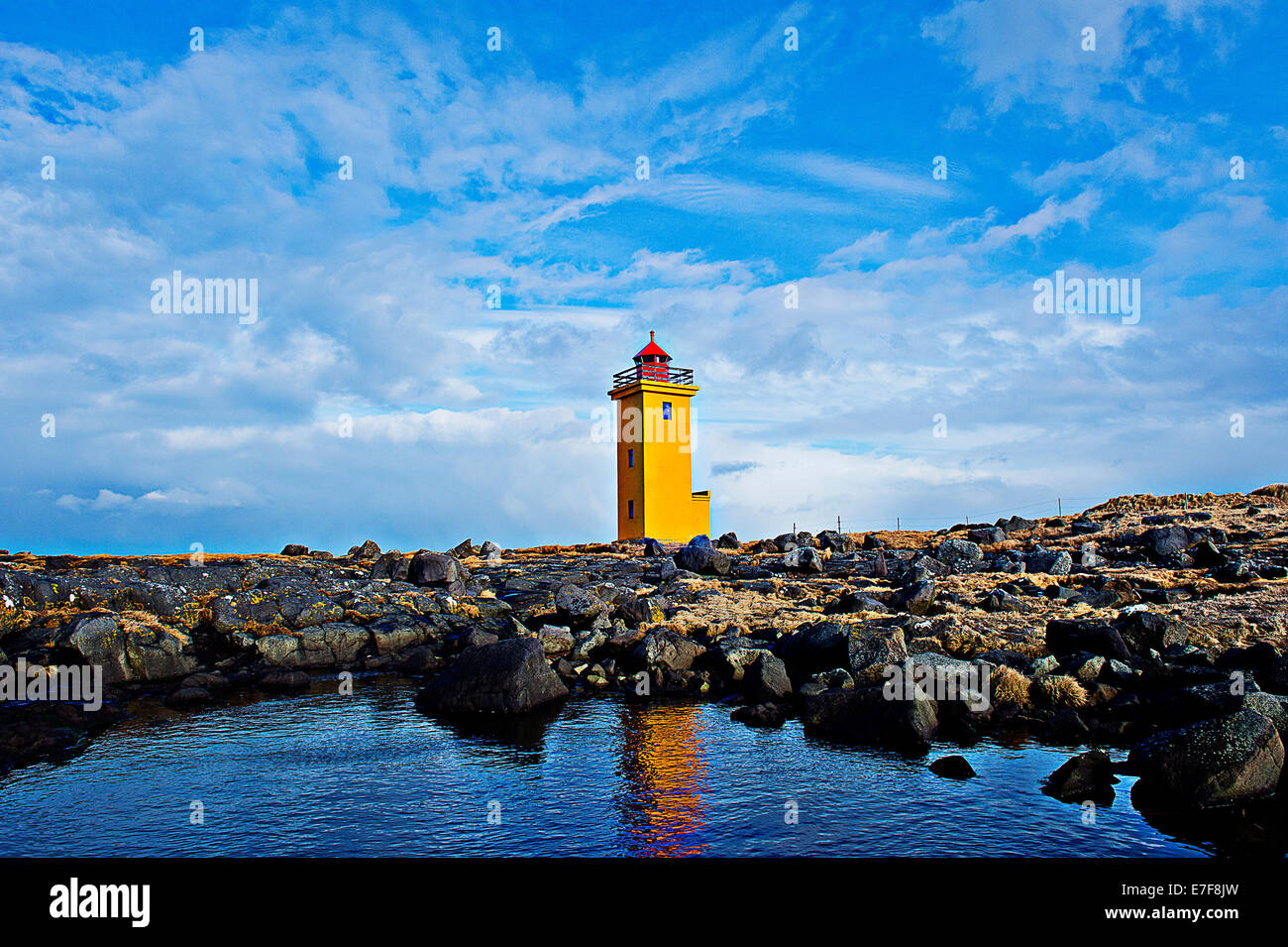 Lighthouse overlooking rocky landscape Stock Photo - Alamy