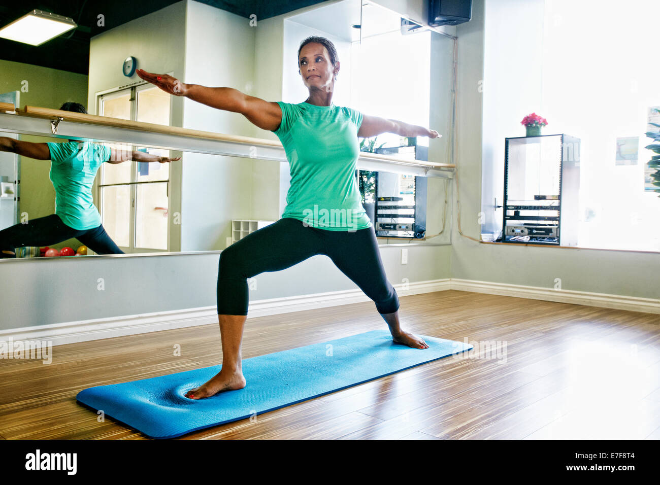 Black woman practicing yoga in studio Stock Photo - Alamy