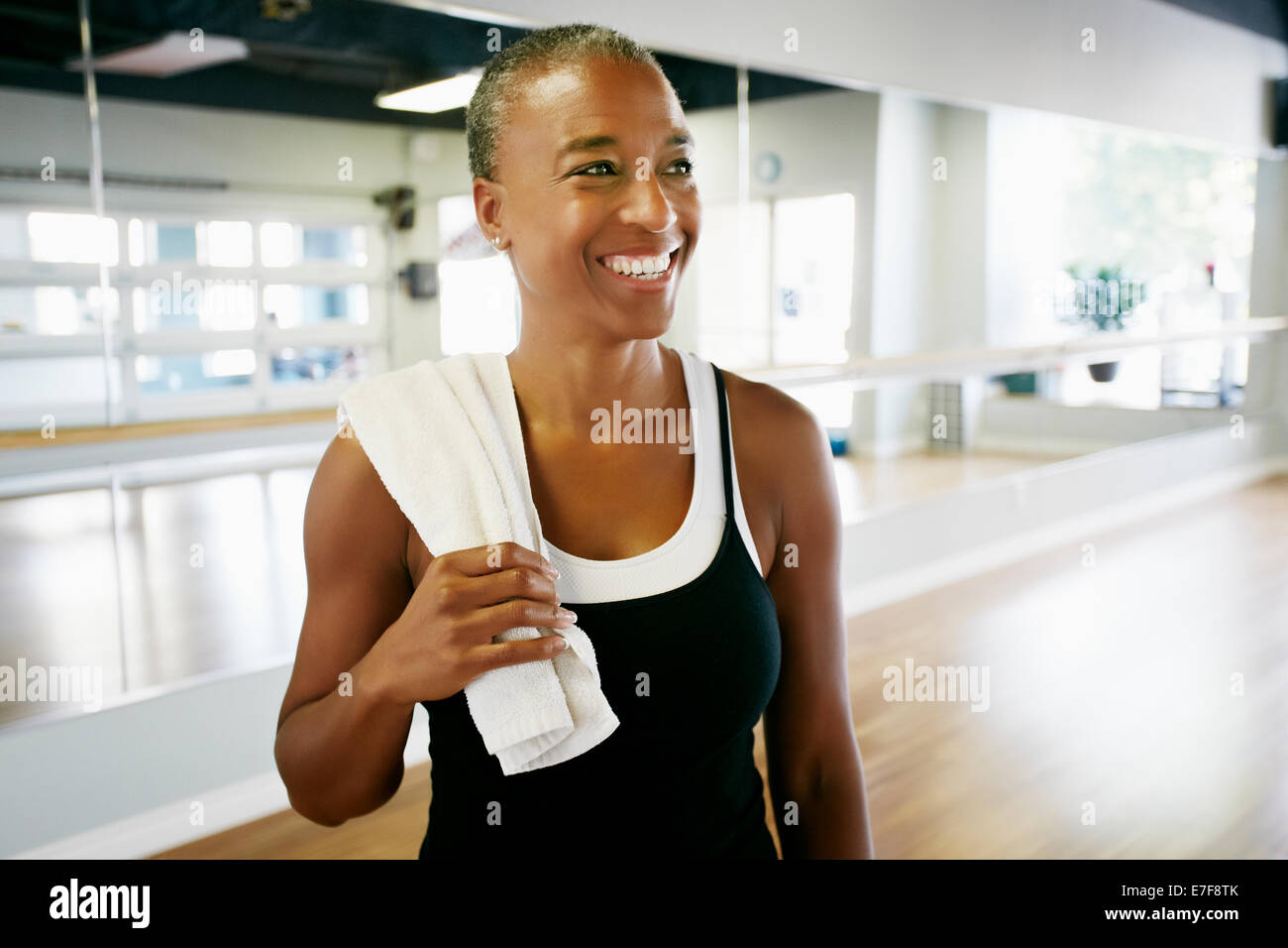 Woman smiling in yoga studio Stock Photo - Alamy