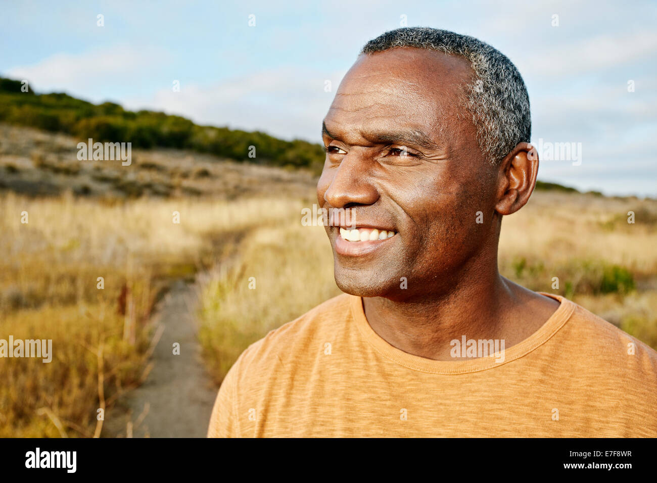 Black man standing on rural path Stock Photo - Alamy