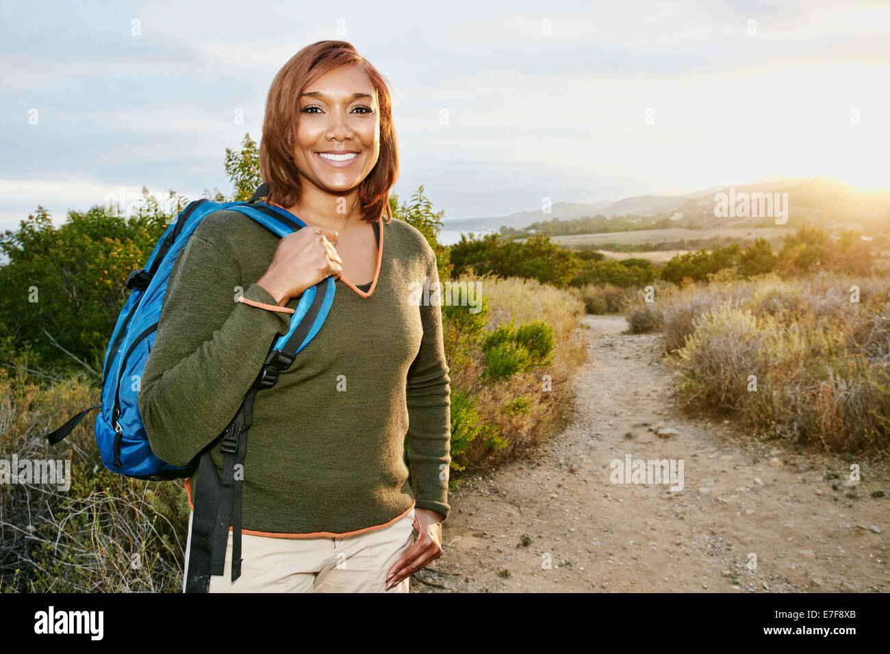 Black woman smiling on rural hillside Stock Photo - Alamy