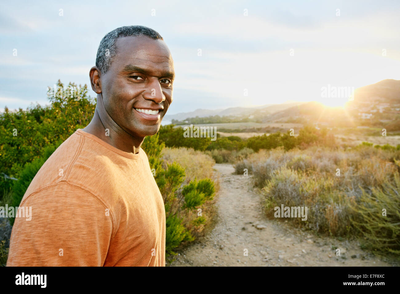 Black man smiling on rural hillside Stock Photo - Alamy