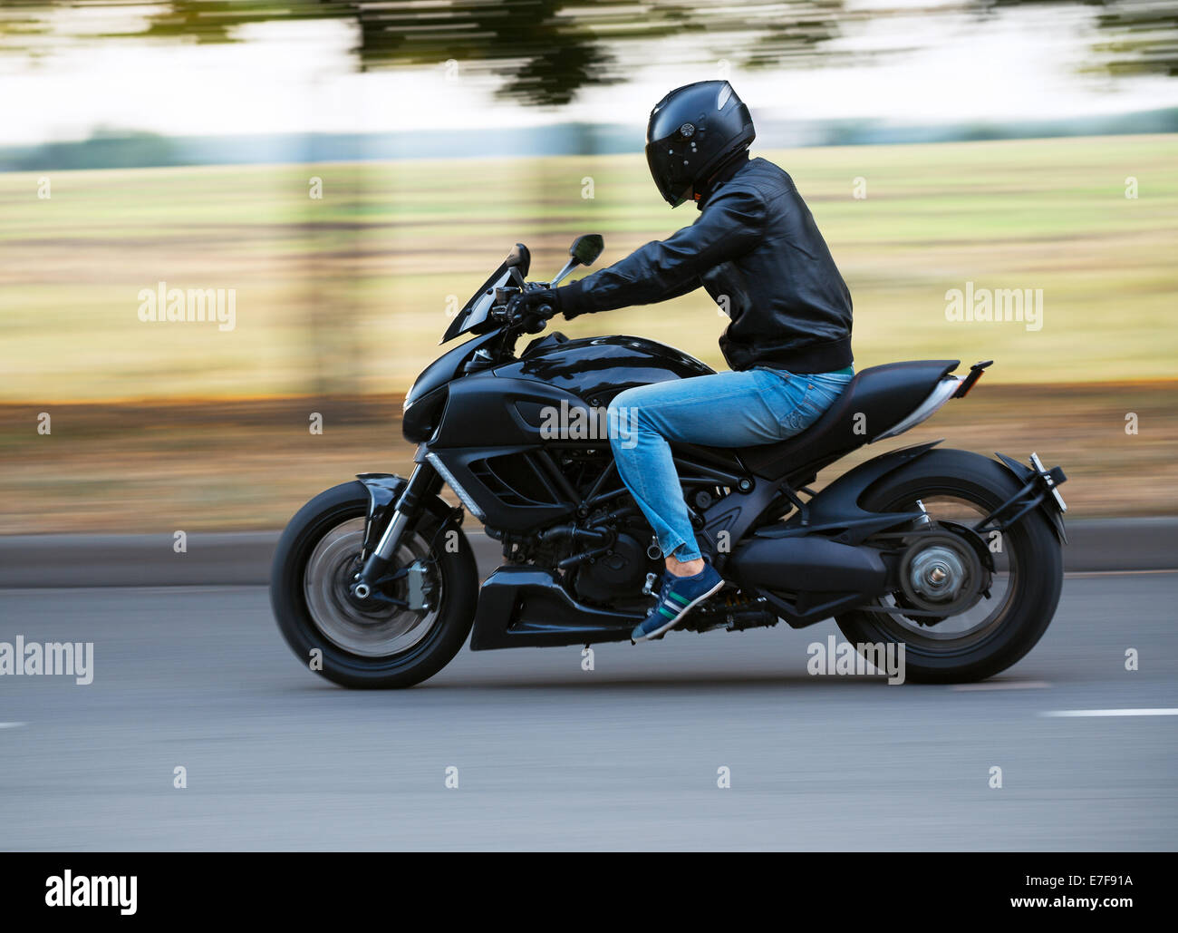 Young man riding a sport motorcycle on the road Stock Photo - Alamy