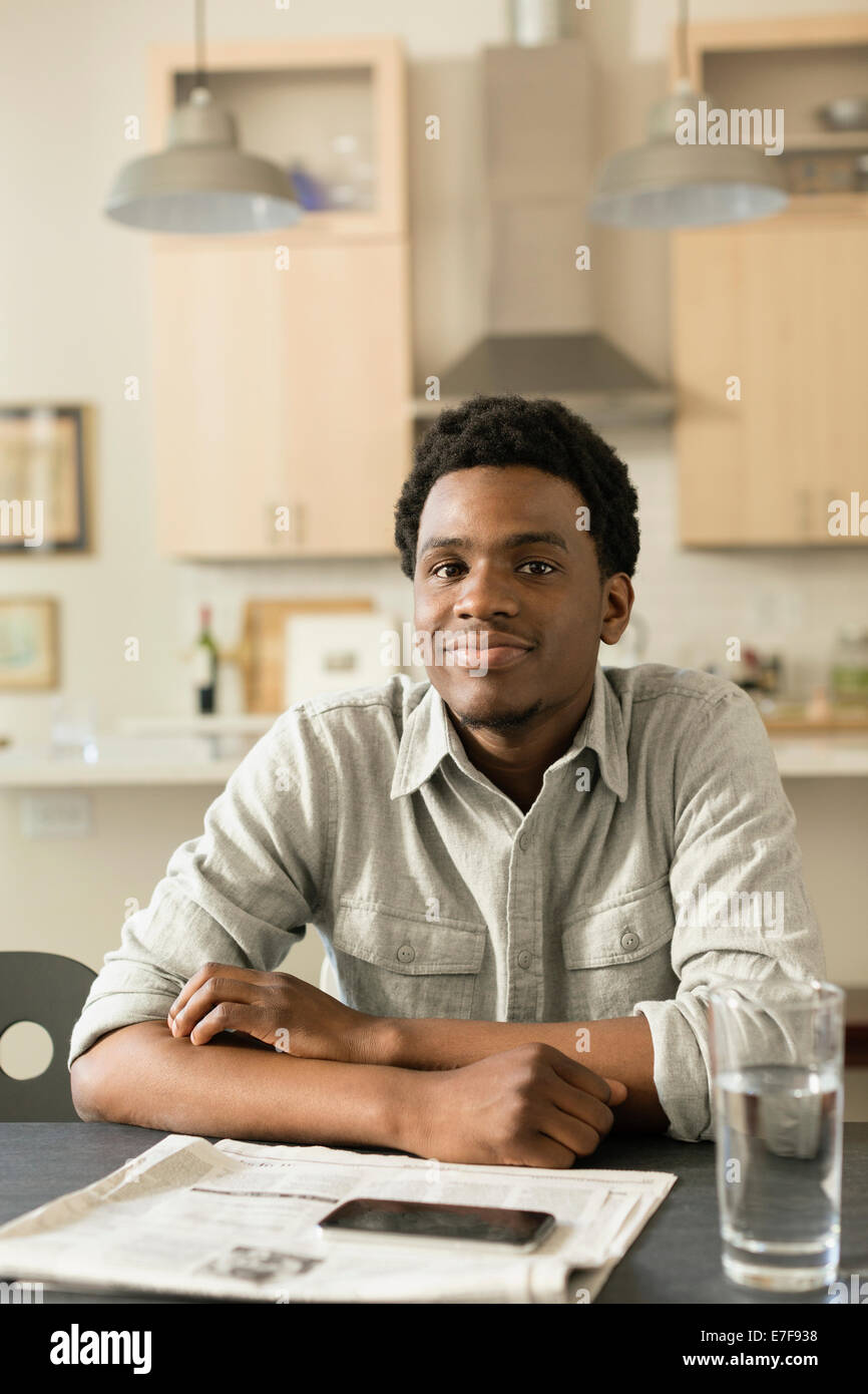 Black man reading newspaper at breakfast table Stock Photo - Alamy
