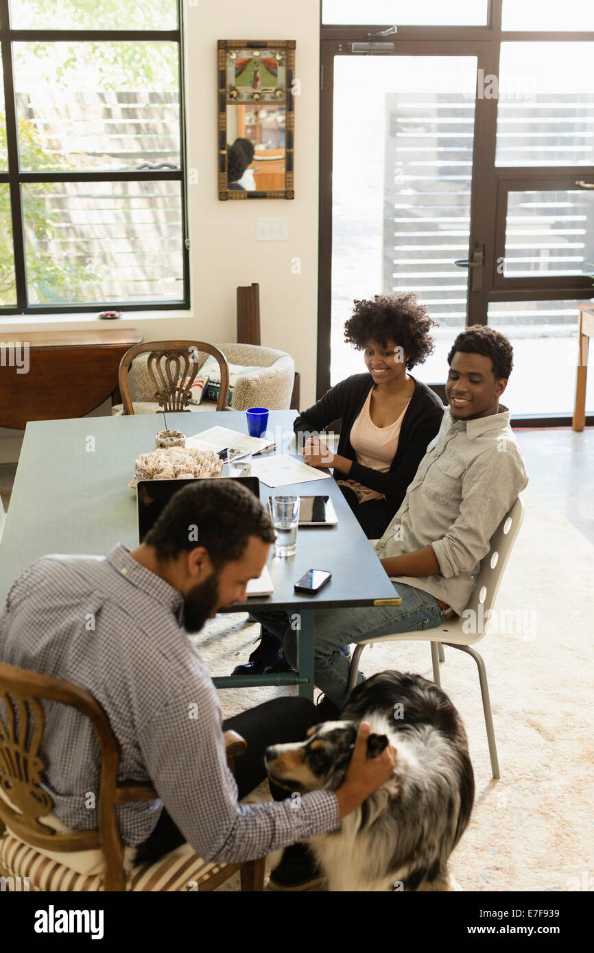 Friends relaxing together at table Stock Photo - Alamy