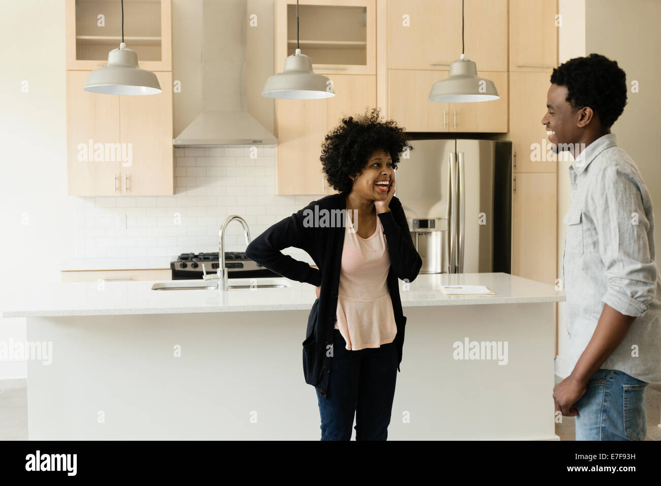 Couple talking in kitchen in new house Stock Photo - Alamy