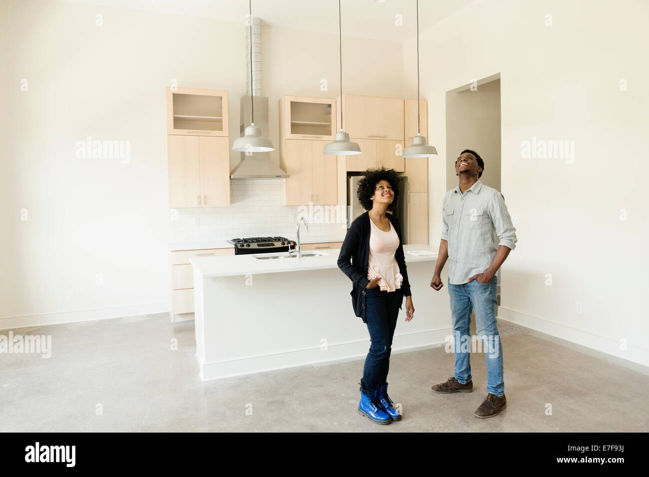 Couple standing in kitchen in new house Stock Photo - Alamy