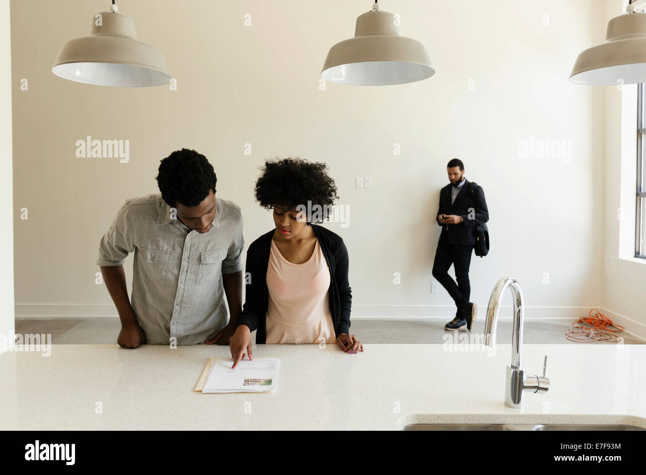 Couple reading paperwork in new house Stock Photo - Alamy