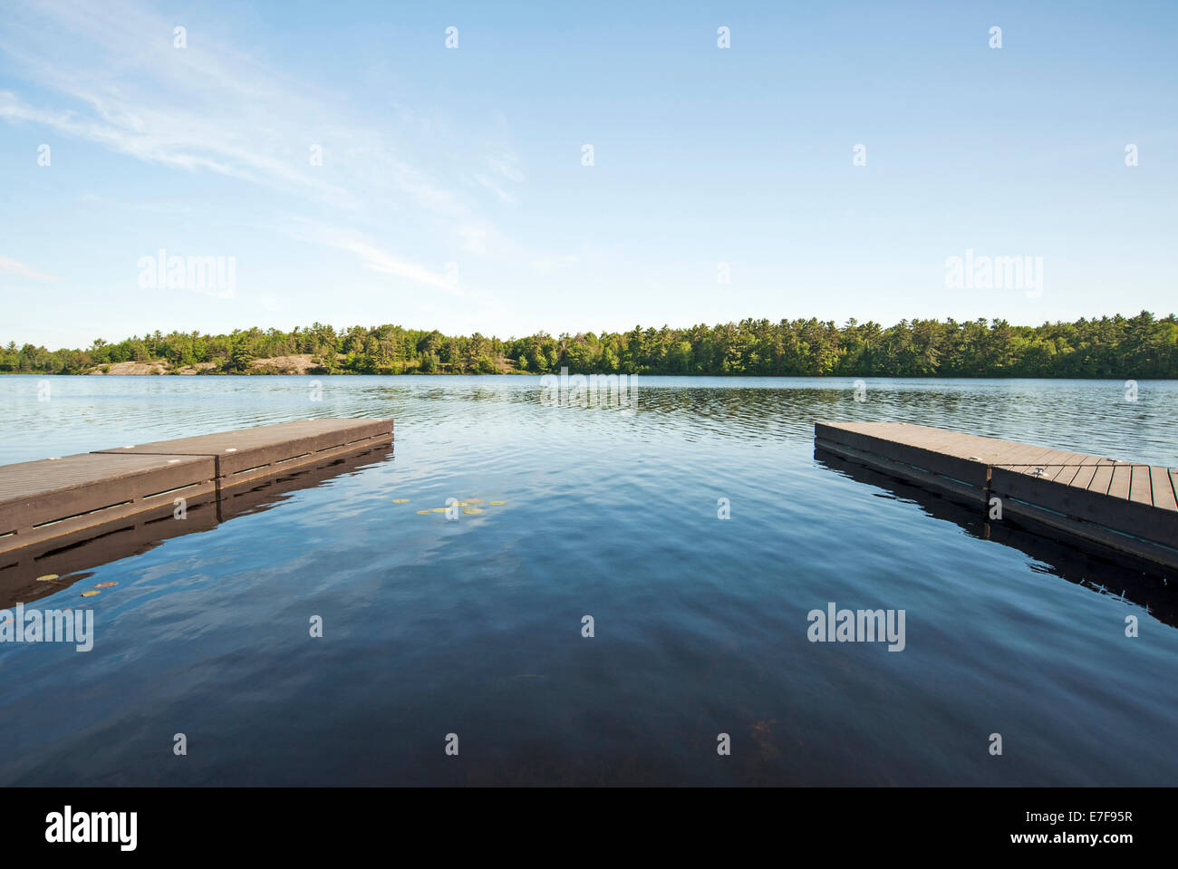 Wooden docks over still river in rural landscape Stock Photo - Alamy