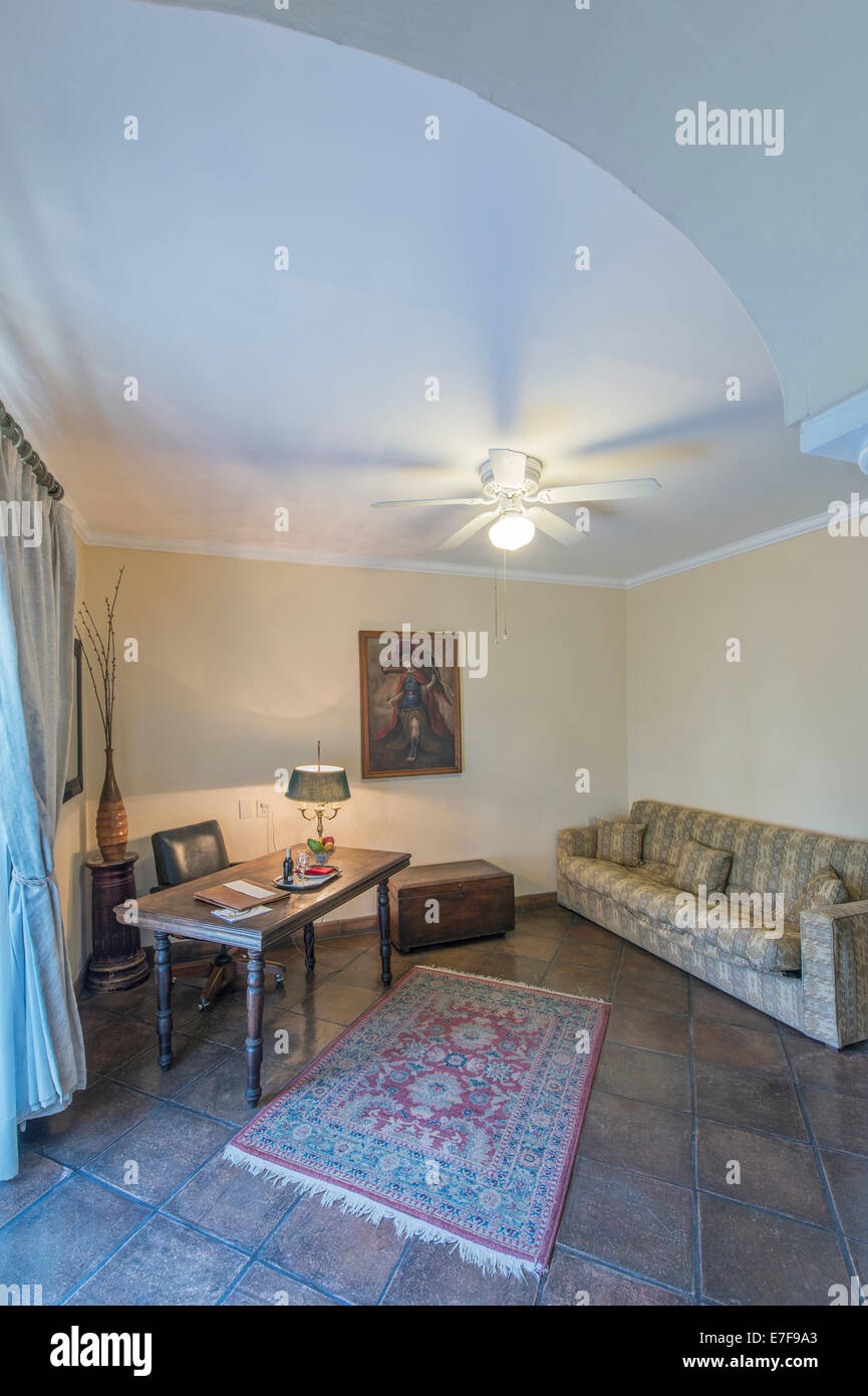 Sofa, desk and trunks in traditional hotel room Stock Photo - Alamy