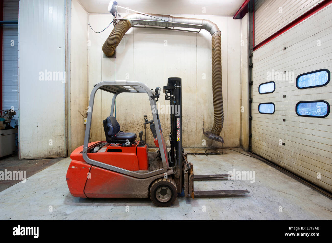 Forklift machinery parked in warehouse Stock Photo - Alamy