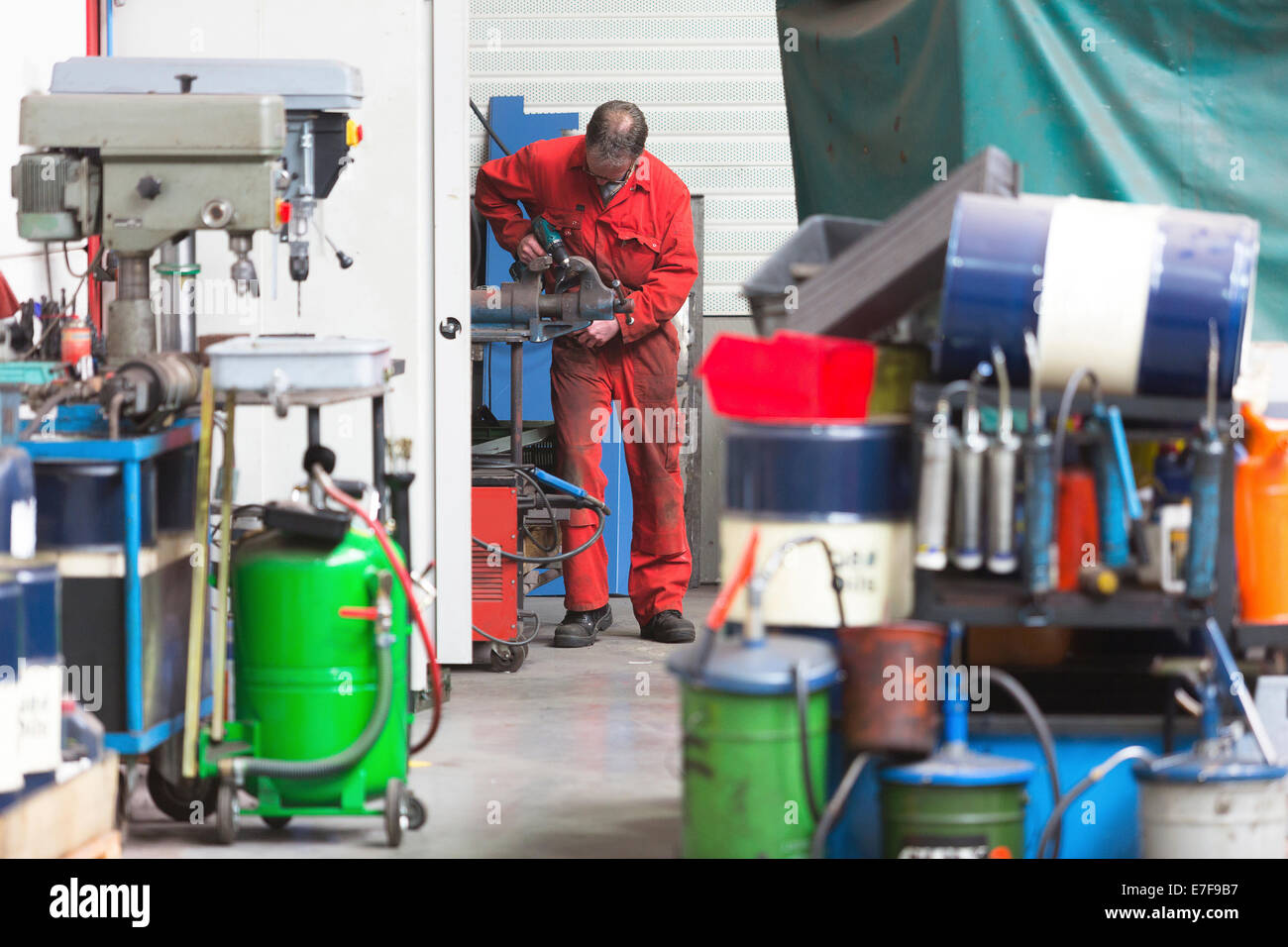 Worker using machinery in warehouse Stock Photo - Alamy
