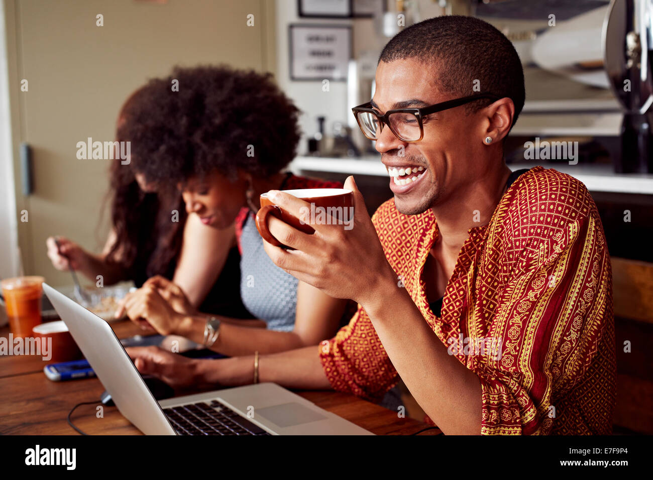People using technology in coffee shop Stock Photo - Alamy