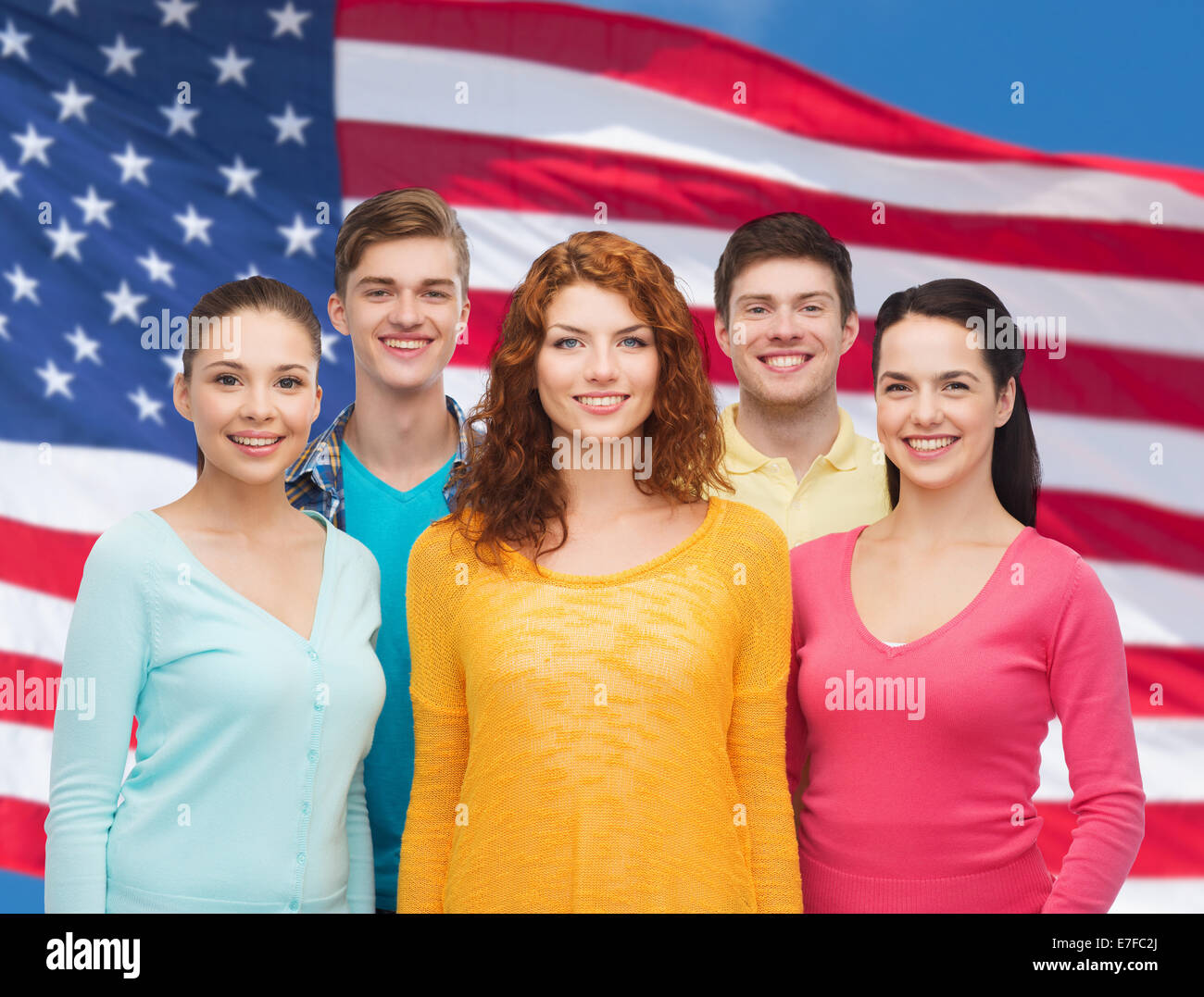 group of smiling teenagers over american flag Stock Photo - Alamy