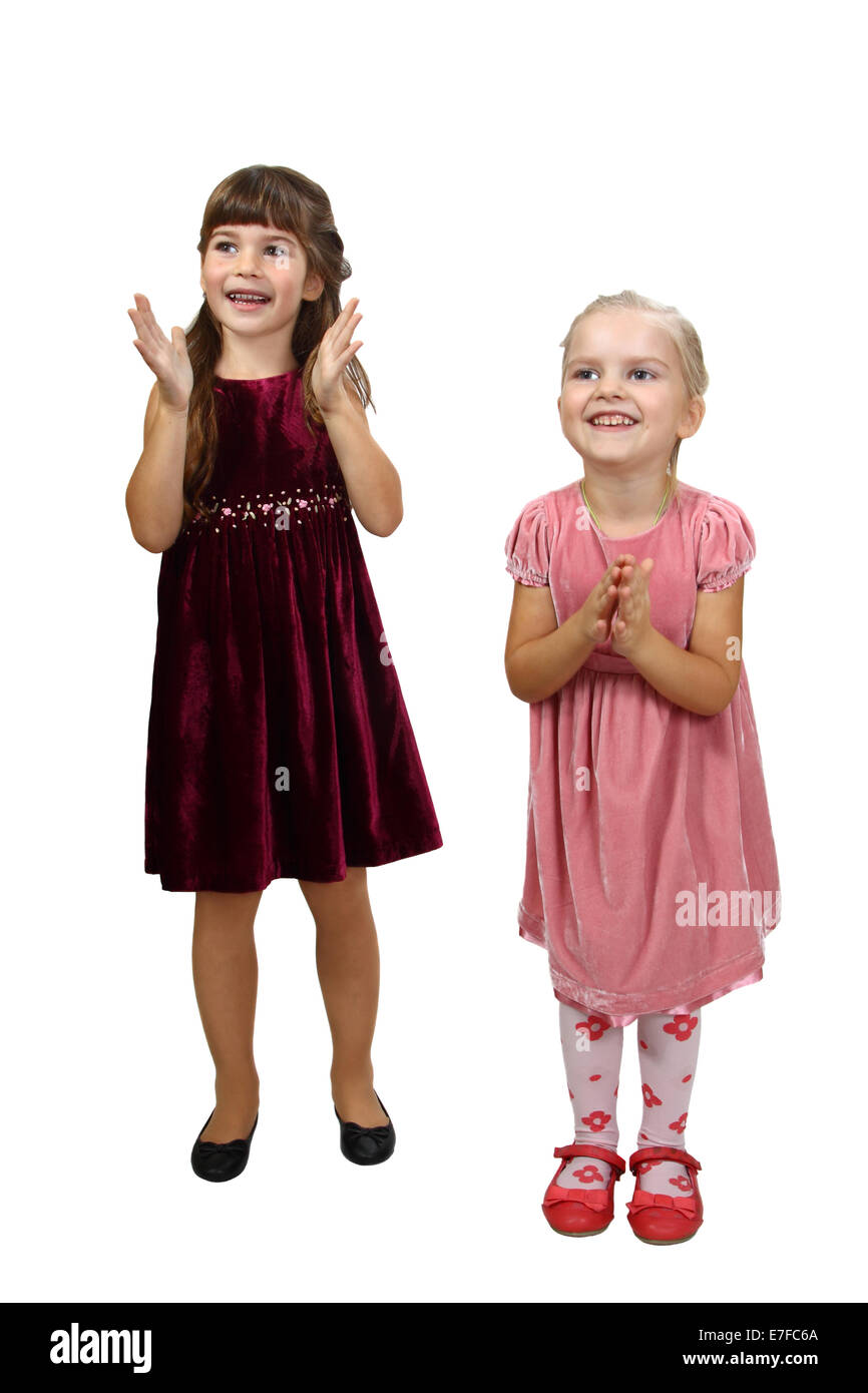 Two little girls joyfully clapping. Portrait isolated on white ...