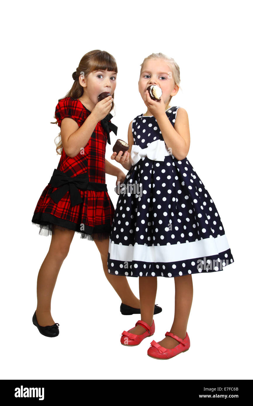 Two little girls eat cakes. Portrait isolated on white background Stock ...