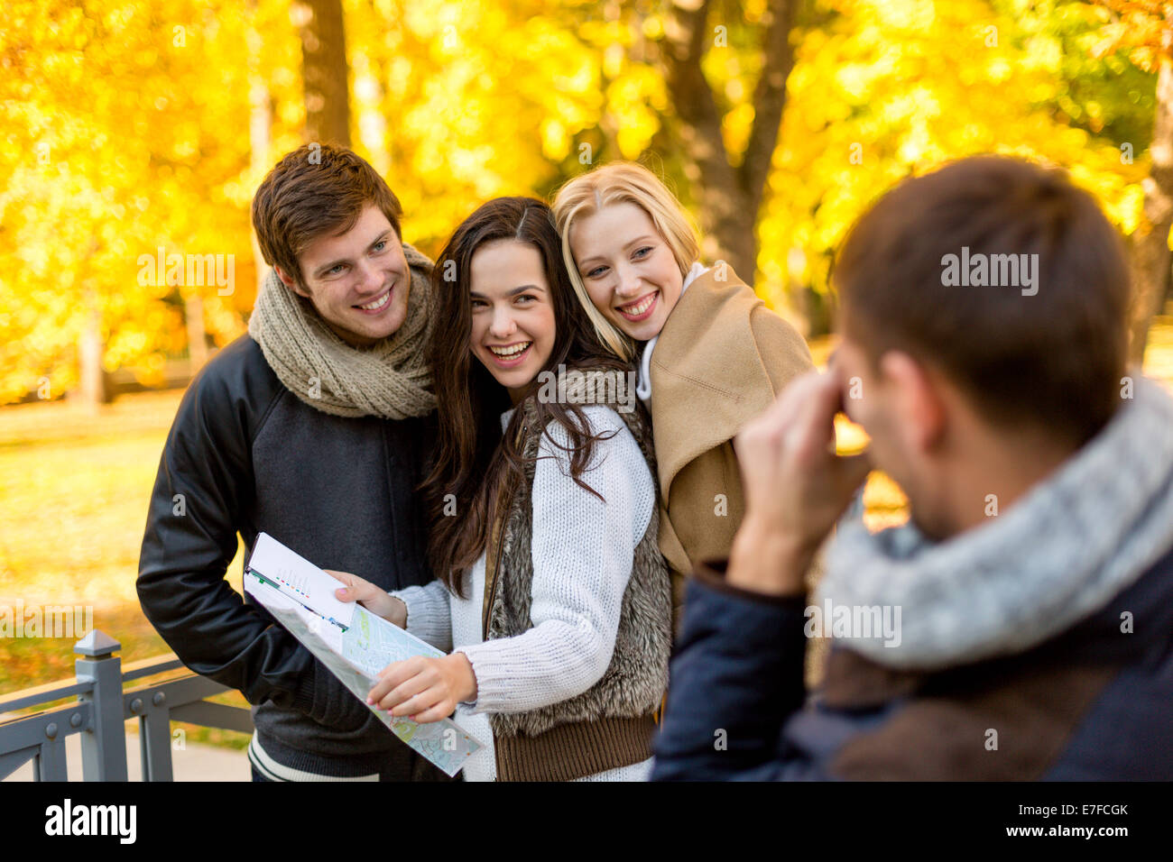 group of friends with map outdoors Stock Photo - Alamy