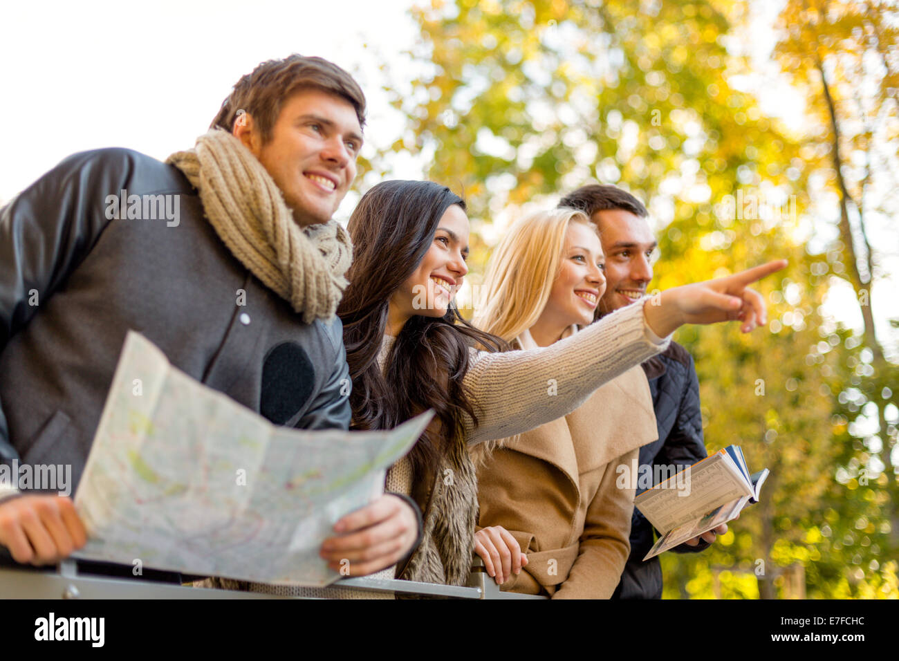 group of friends with map outdoors Stock Photo - Alamy