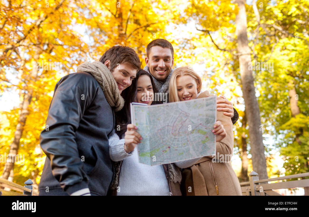 group of friends with map outdoors Stock Photo - Alamy