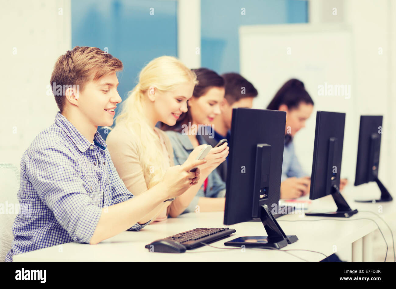 students with computer monitor and smartphones Stock Photo - Alamy