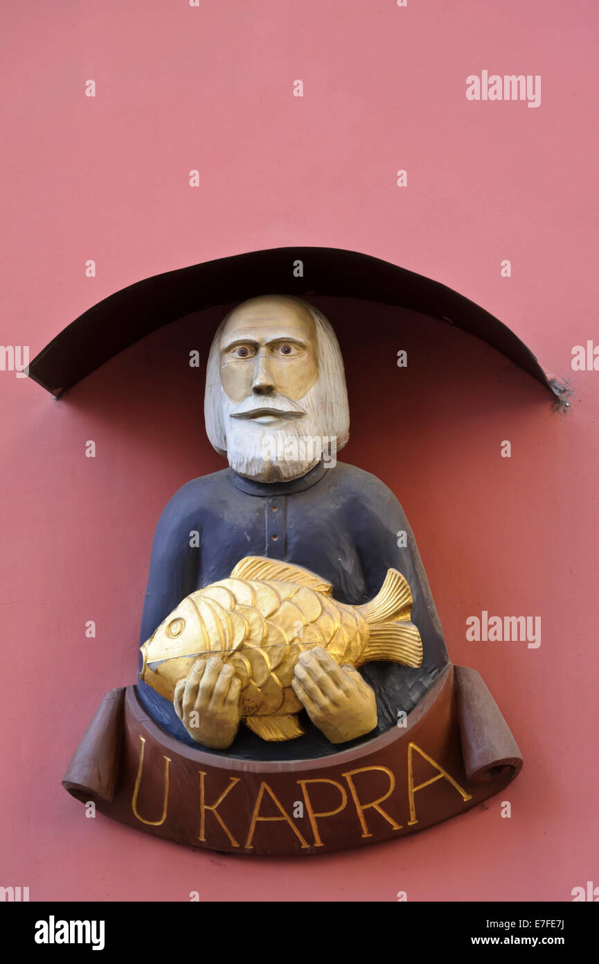 An old man holding a fish is the sign of U Kapra fish restaurant in Old ...