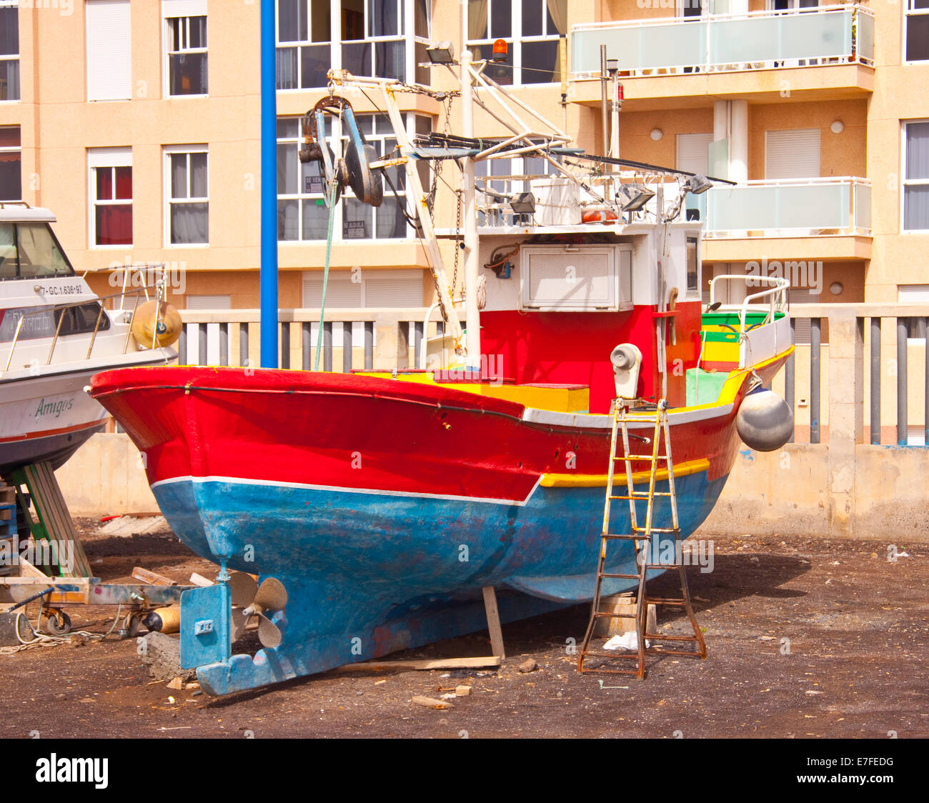 Bright red boat in boatyard on Canary Islands Stock Photo - Alamy