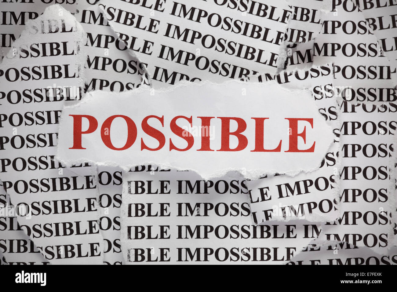 Torn pieces of paper with the word "Impossible" and word "Possible" in ...
