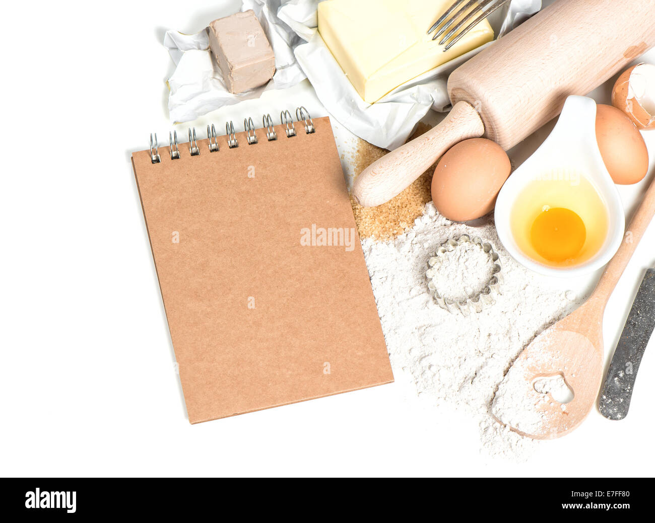 baking ingredients eggs, flour, sugar, butter, yeast and recipe book ...