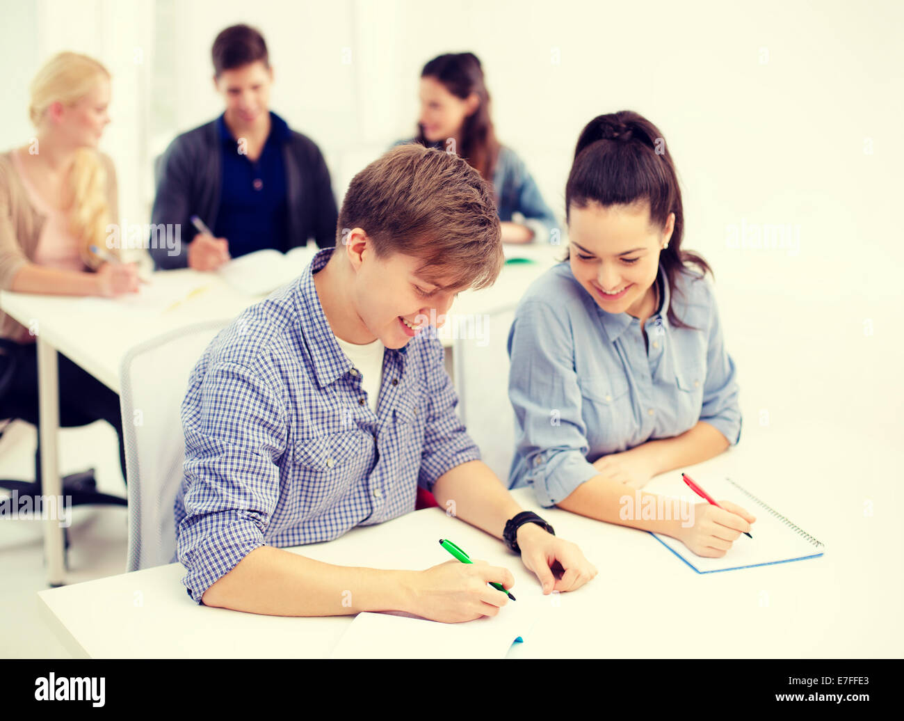smiling students with notebooks at school Stock Photo - Alamy
