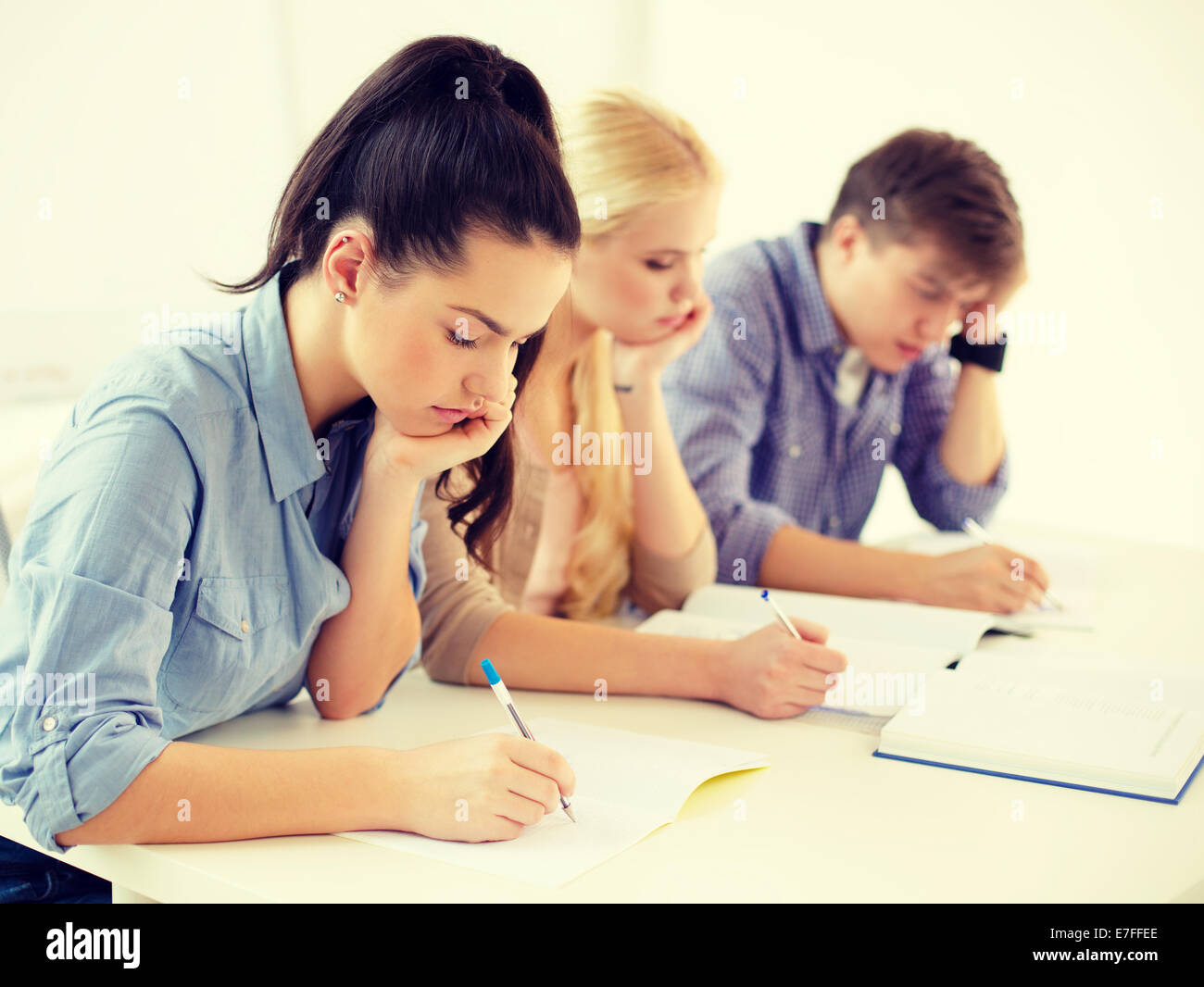 tired students with notebooks at school Stock Photo - Alamy