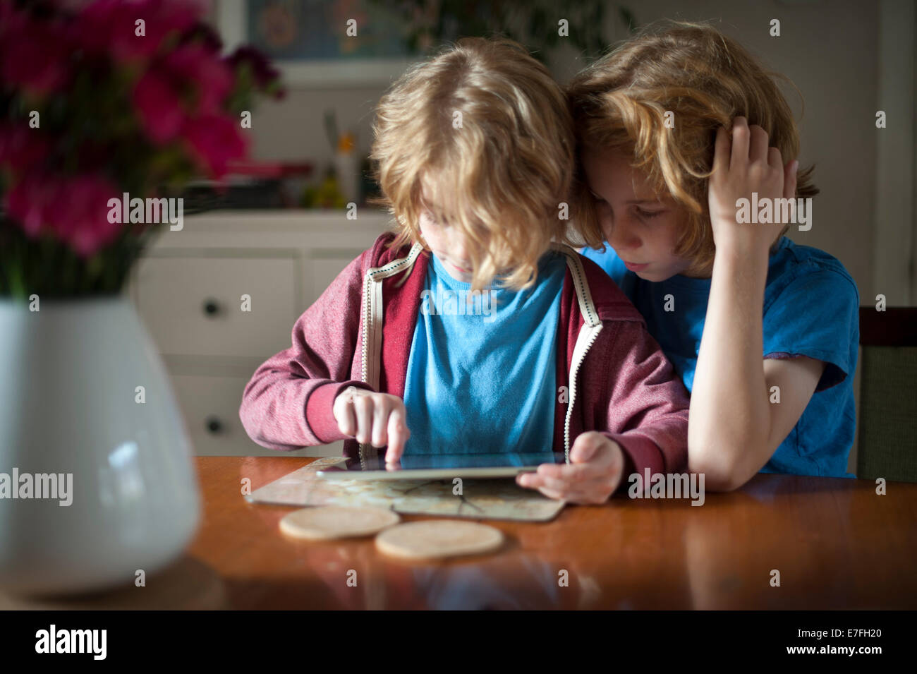 brothers using a tablet computer together Stock Photo - Alamy