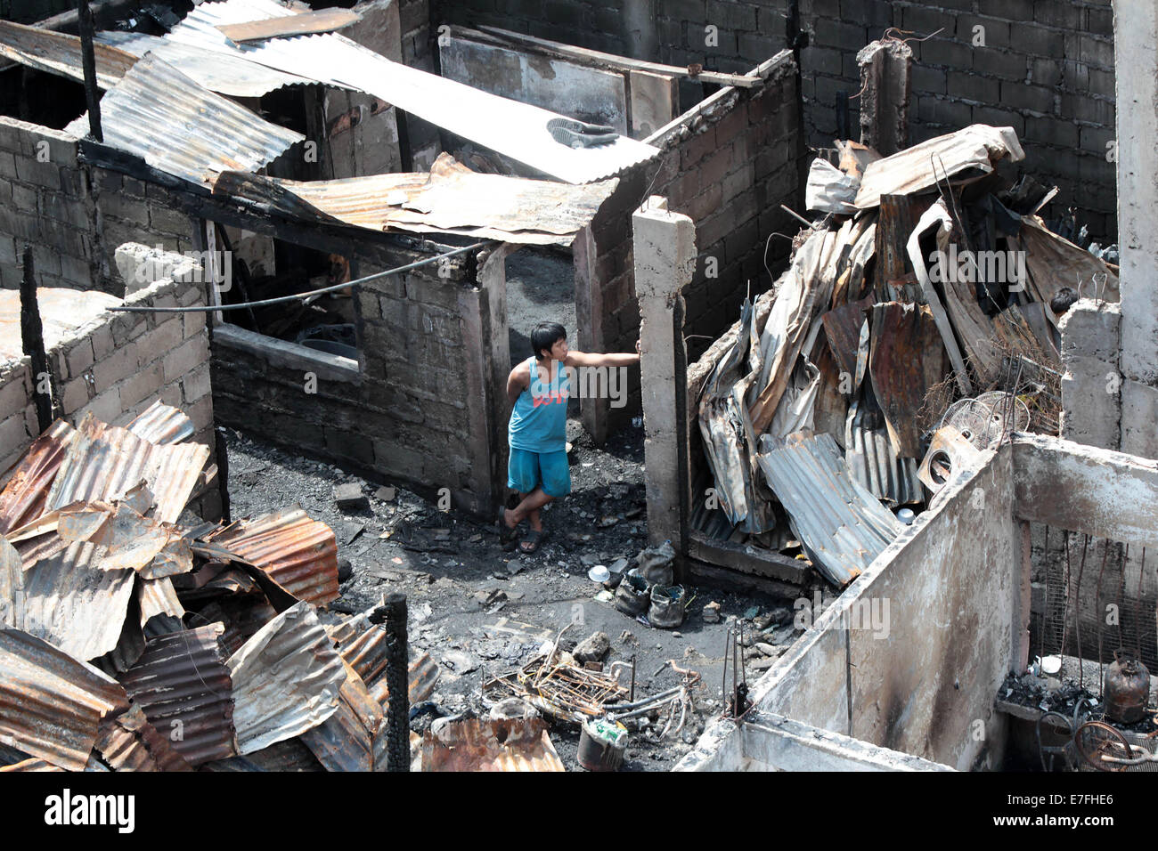 Paranaque City, Philippines. 16th Sep, 2014. A resident stands outside ...