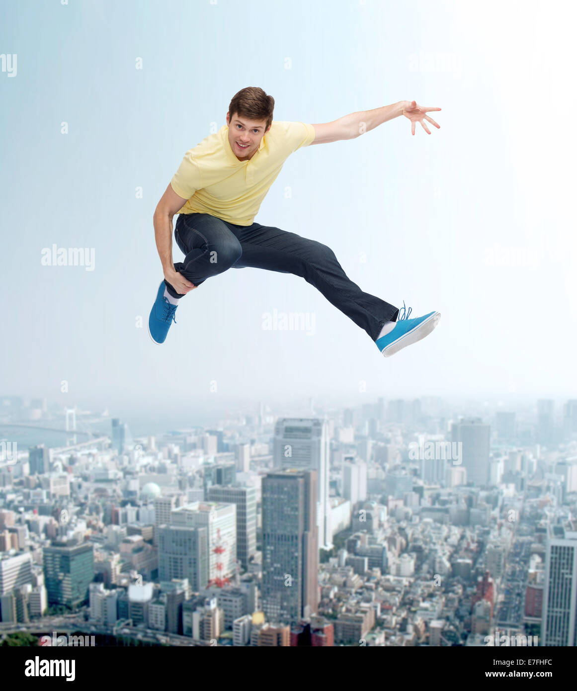 smiling young man jumping in air Stock Photo - Alamy