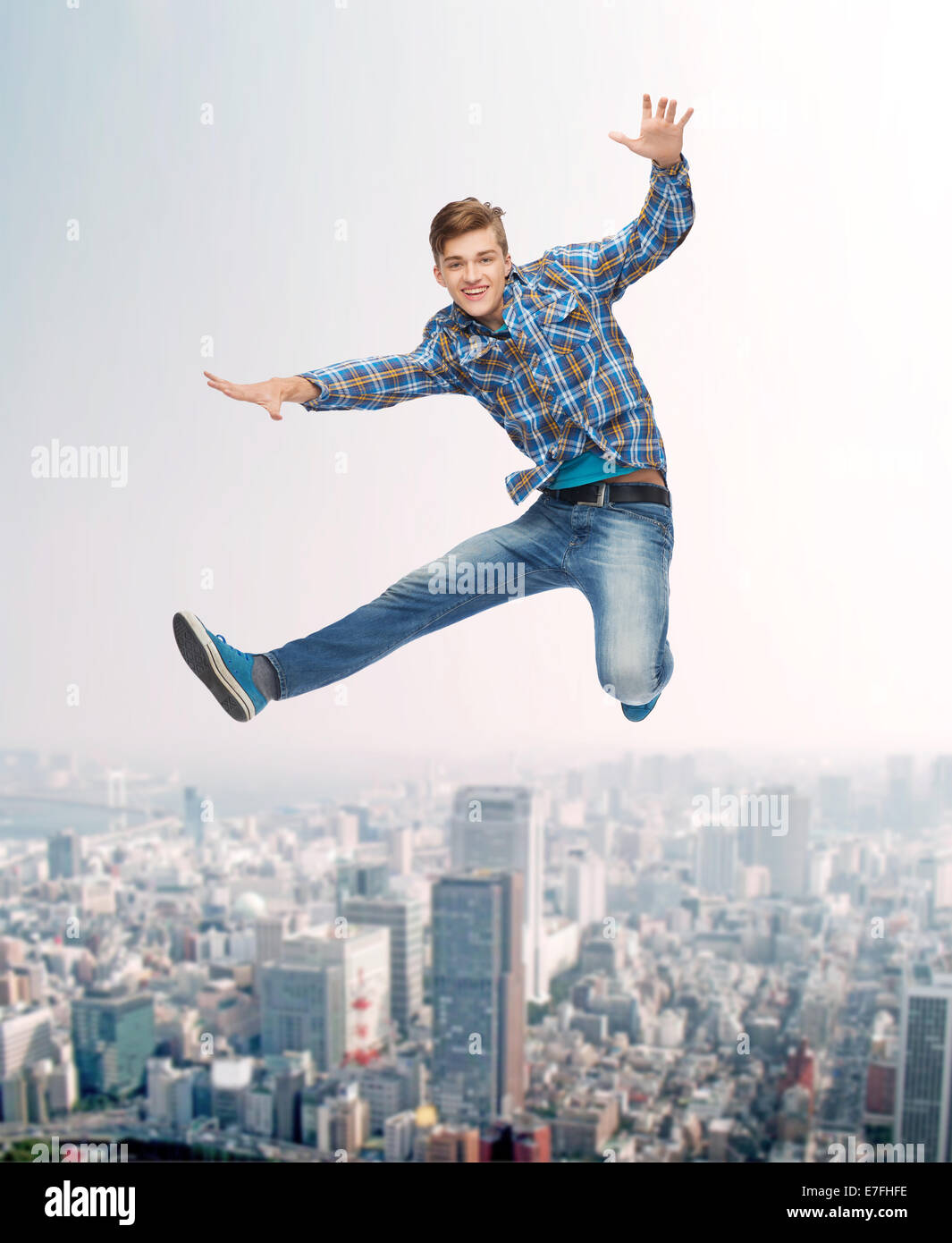 smiling young man jumping in air Stock Photo - Alamy