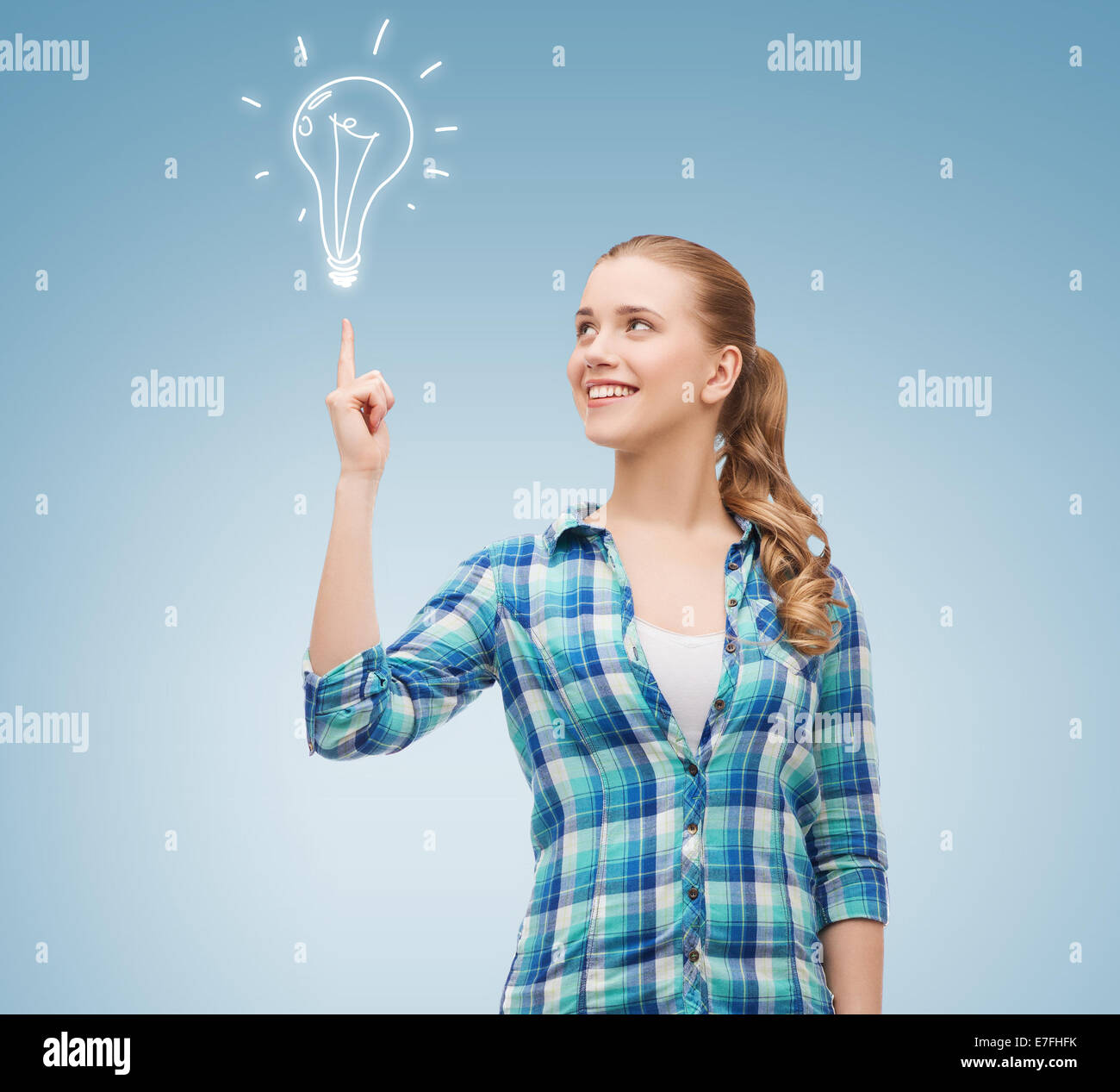 smiling young woman pointing finger up Stock Photo - Alamy smiling young woman pointing finger up Stock Photo - Alamy