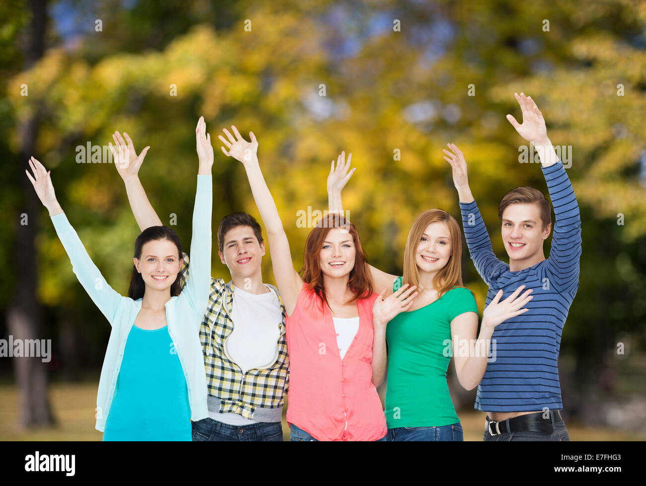group of smiling students waving hands Stock Photo - Alamy
