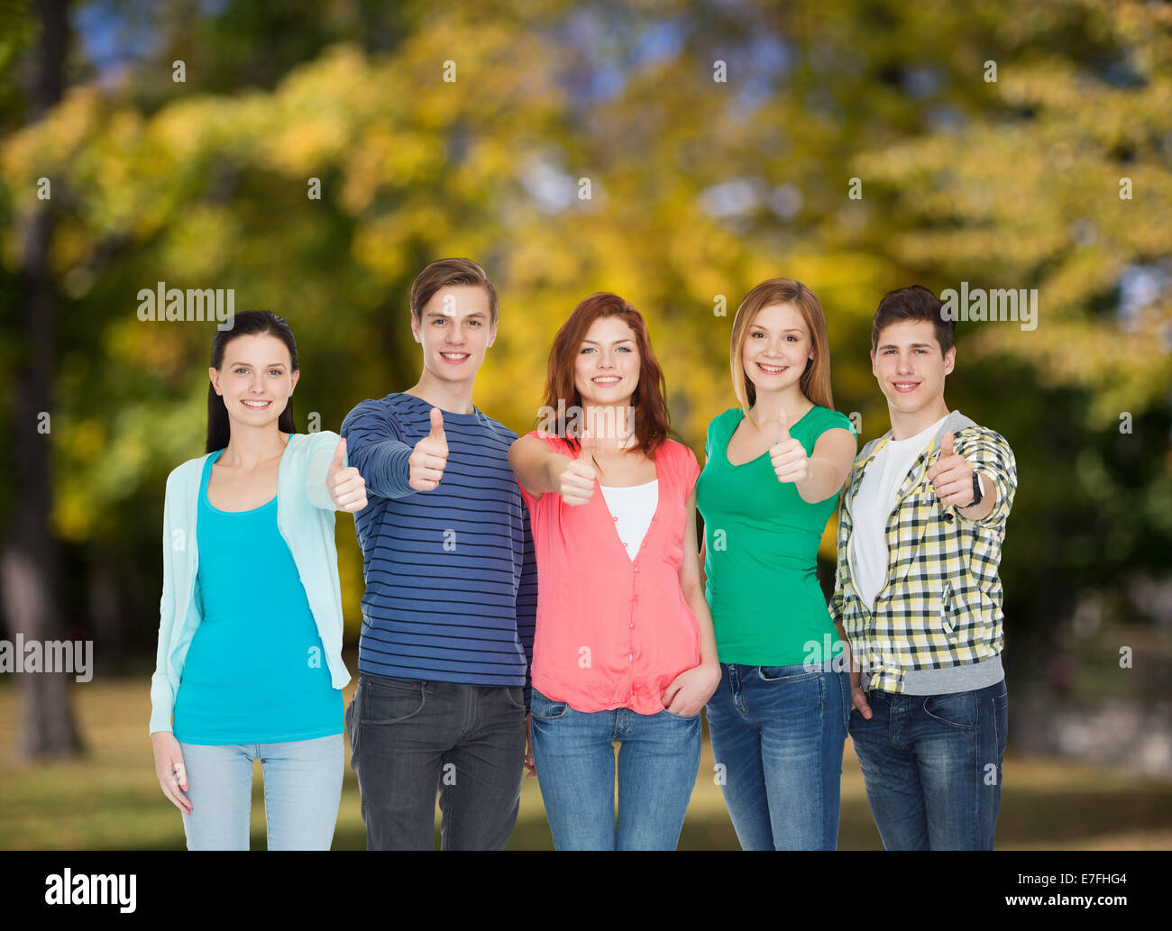 group of smiling students showing thumbs up Stock Photo - Alamy