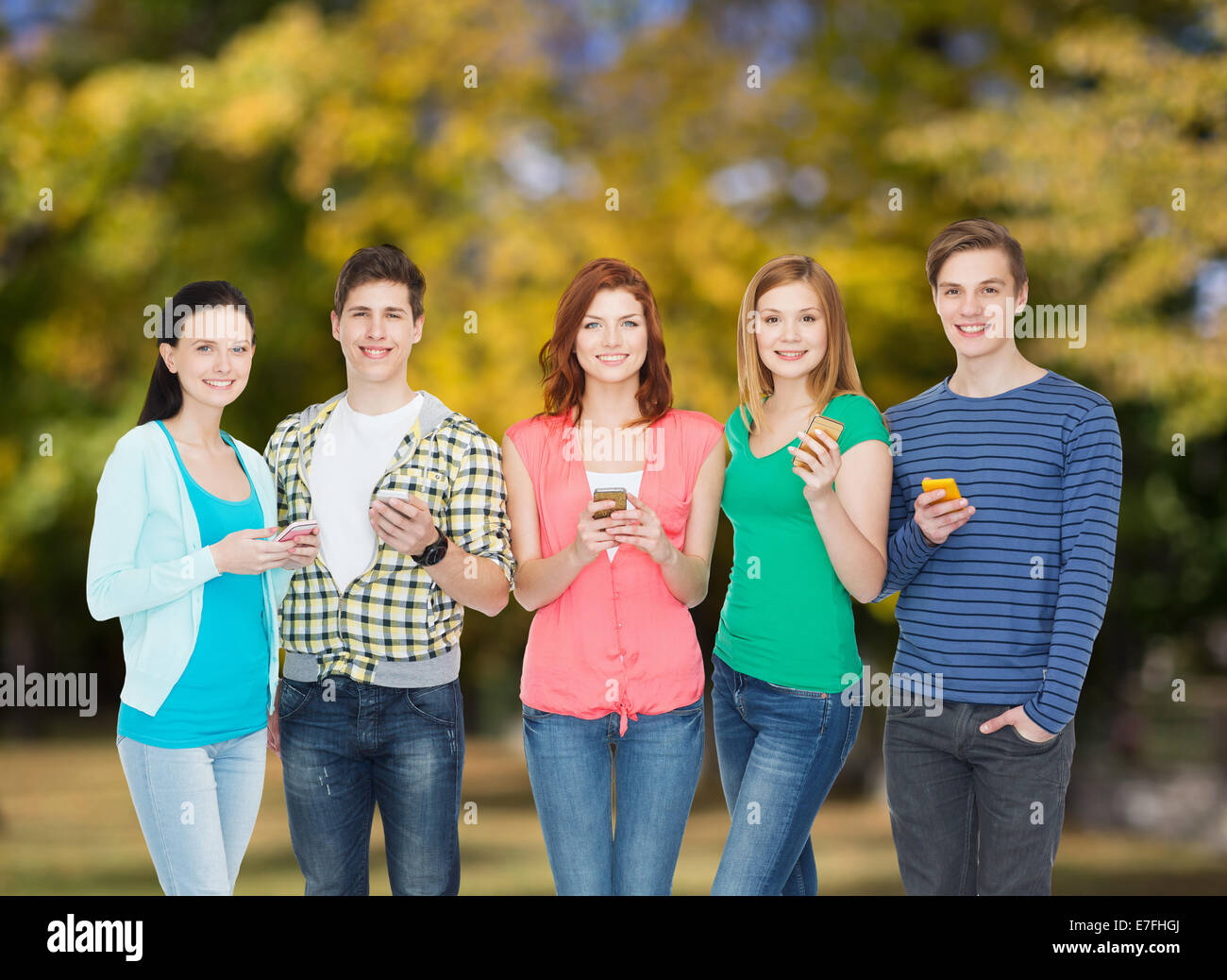 smiling students with smartphones Stock Photo - Alamy