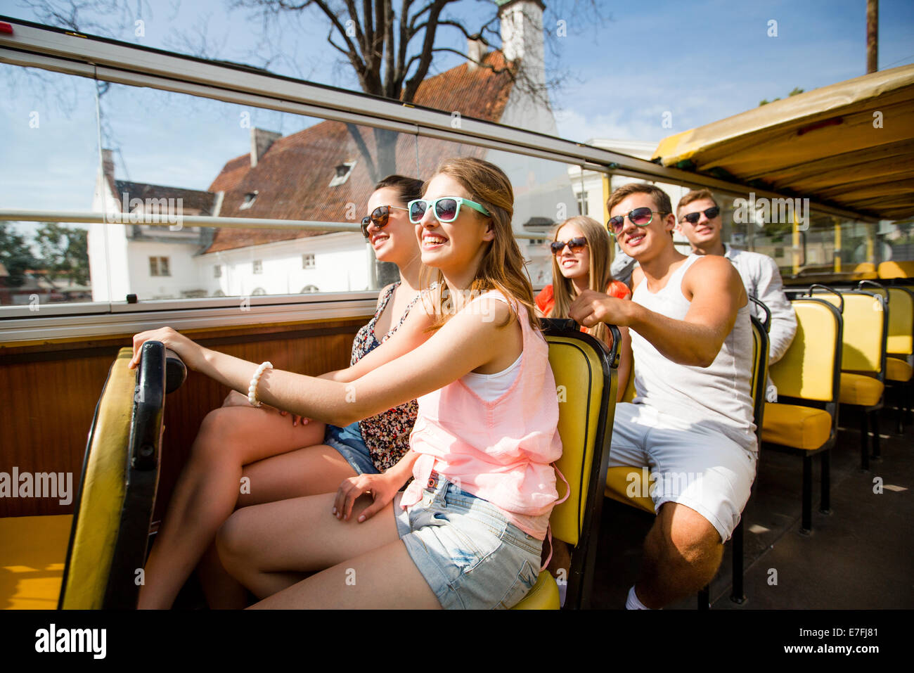 group of smiling friends traveling by tour bus Stock Photo - Alamy
