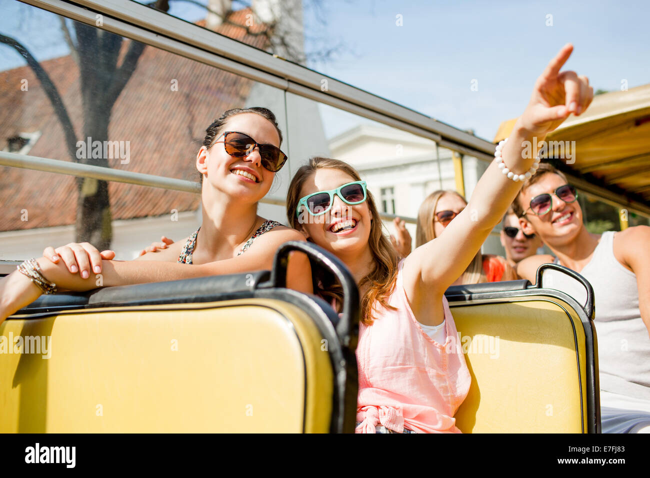 group of smiling friends traveling by tour bus Stock Photo - Alamy
