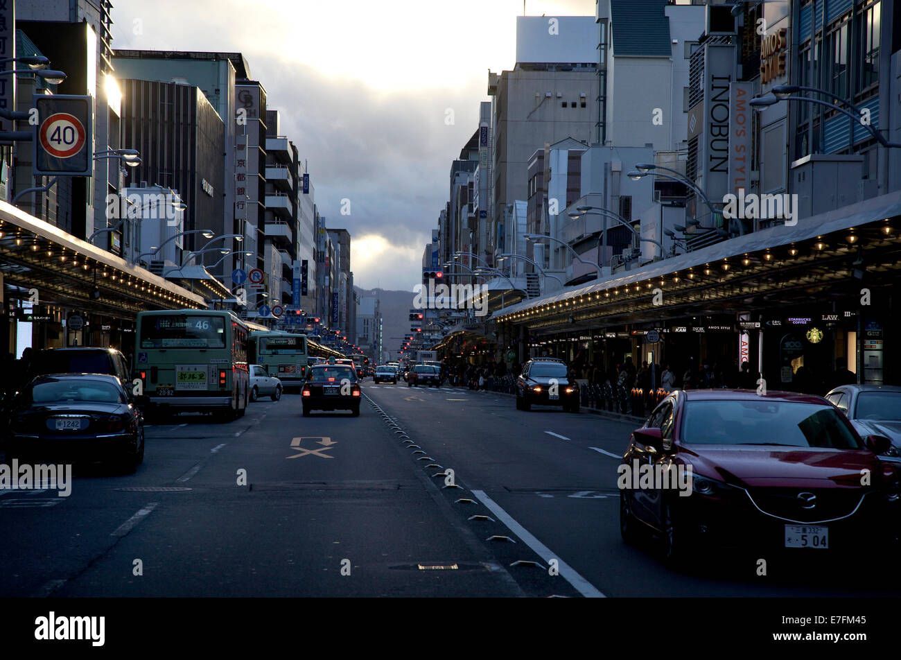 Cars, traffic on the road, red lights in Kawaramachi street at sunset ...