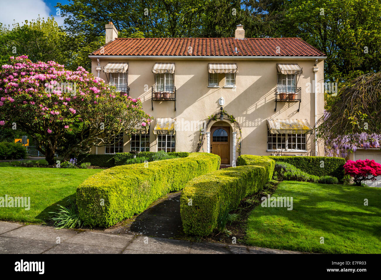 A home with decorative spring flower bushes in Portland, Oregon, USA ...