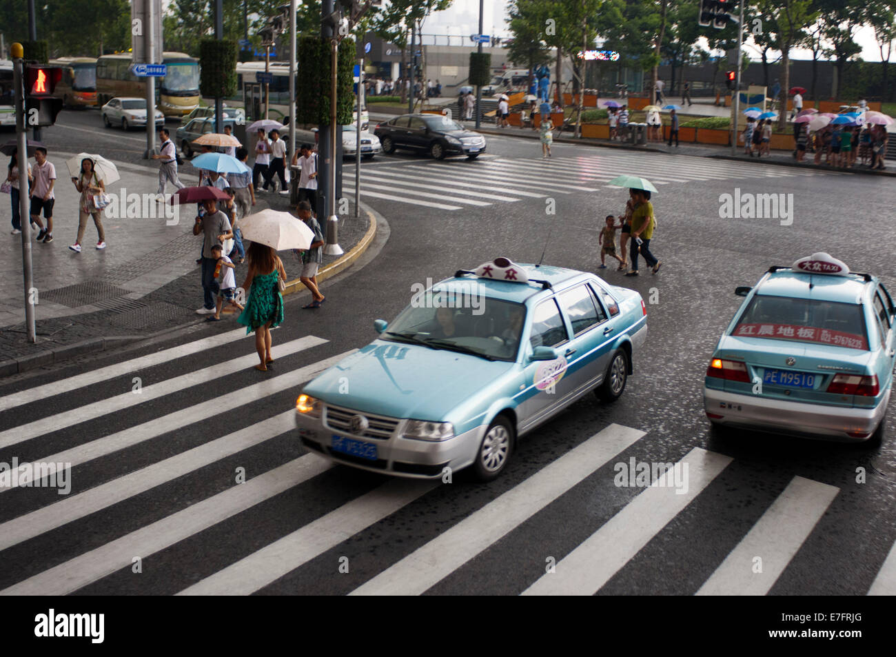 Two taxis in a rain day in Shanghai, China. Volkswagen Santana taxis ...