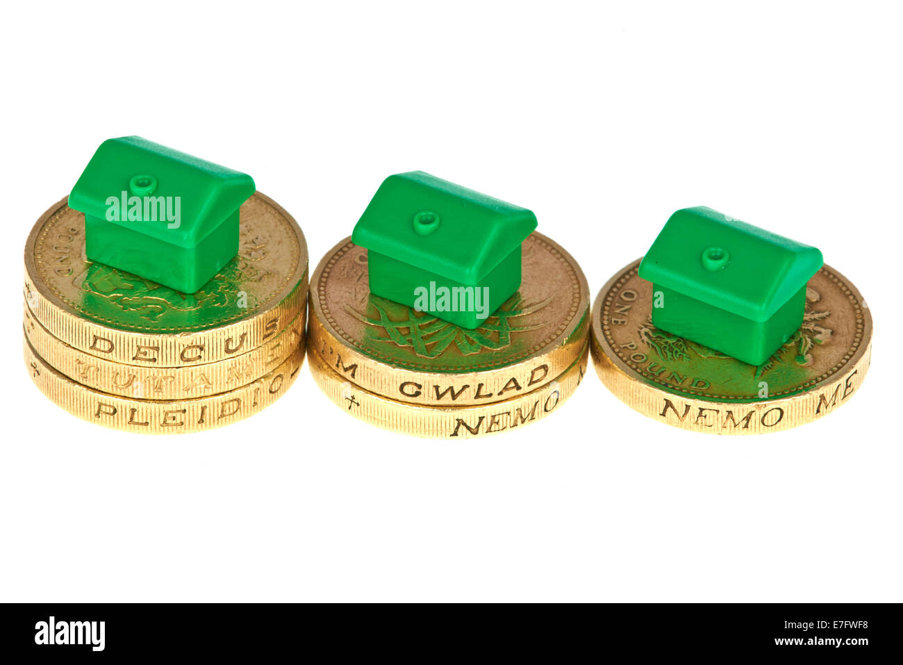 Monopoly Houses On Decreasing Piles Of Pound Coins Stock Photo - Alamy
