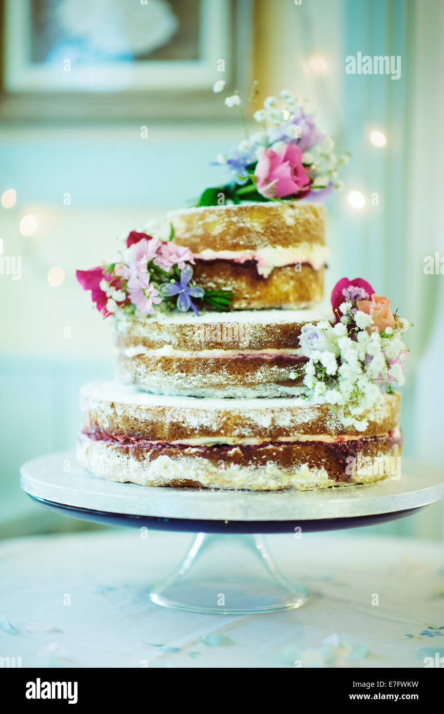 Wedding cake with raspberry jam and cream, and adorned with flowers ...